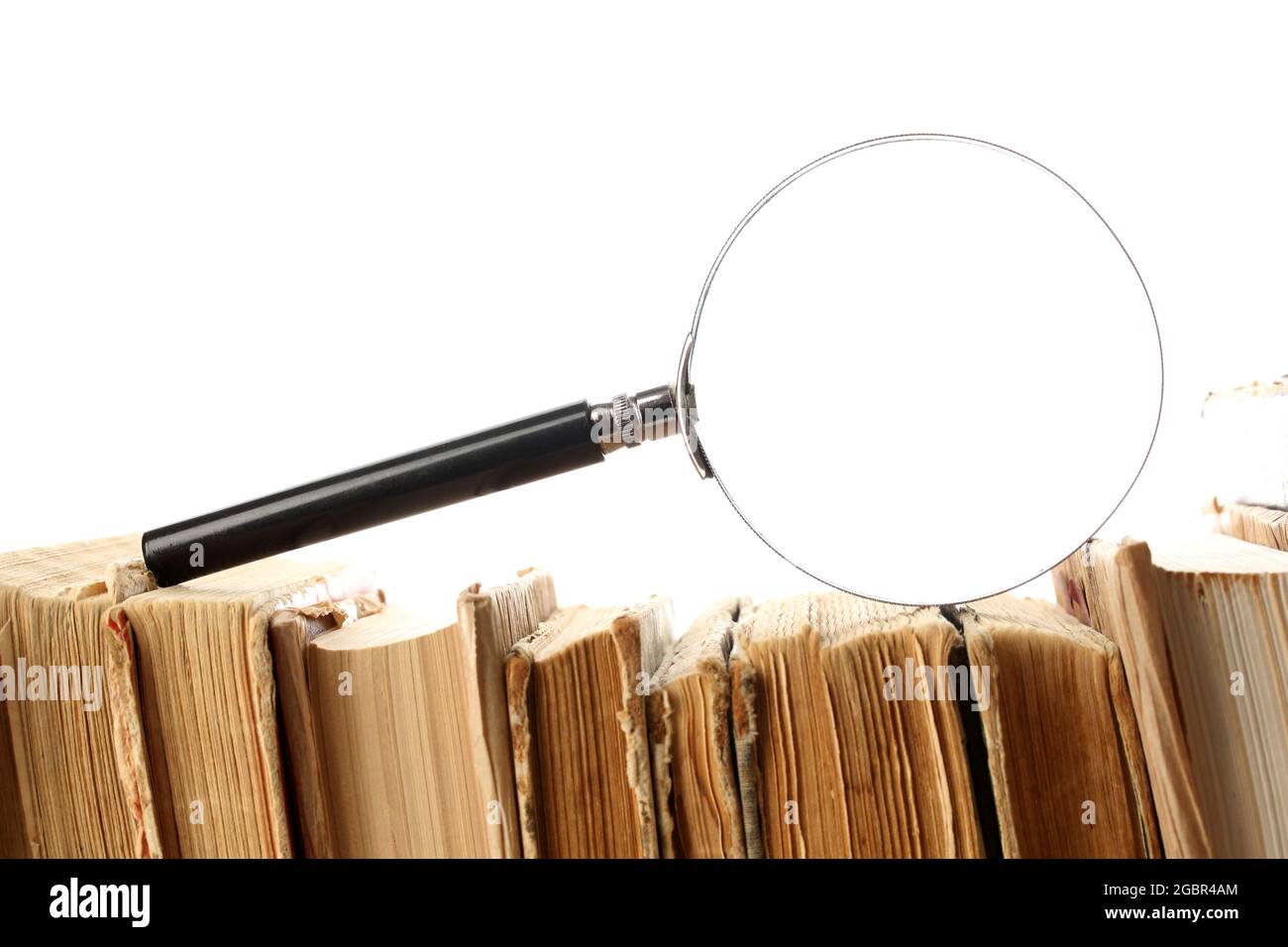 Magnifying glass over the stack of books isolated on white Stock Photo ...