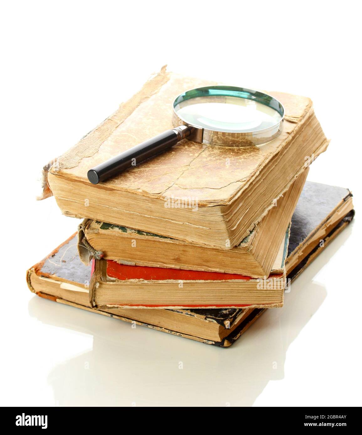 Magnifying glass and books isolated on white Stock Photo - Alamy