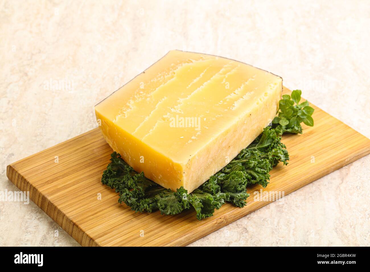 Hard Parmesan cheese piece over board Stock Photo - Alamy