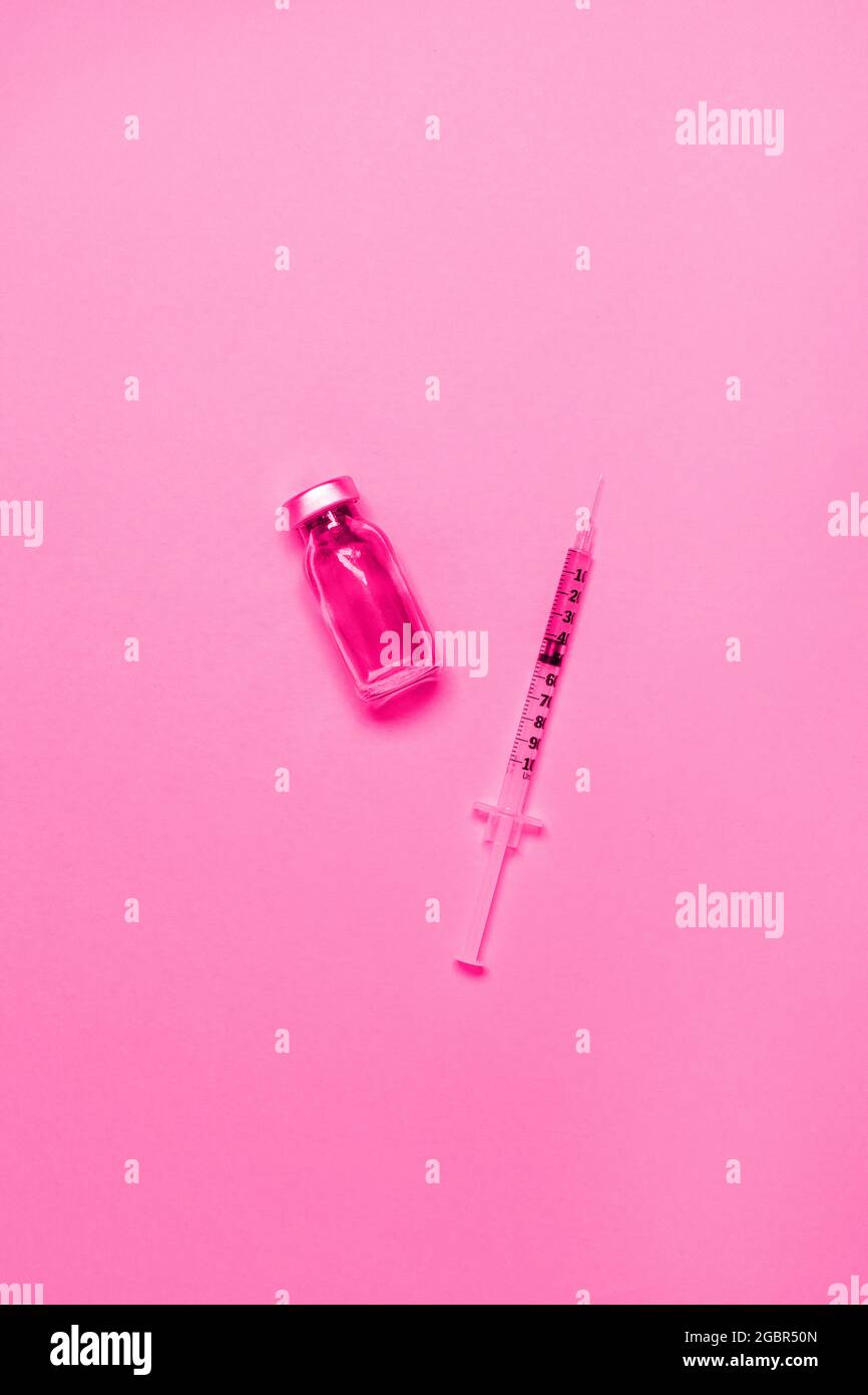 Medical syringe and bottle for injectionon on a pink background, health ...