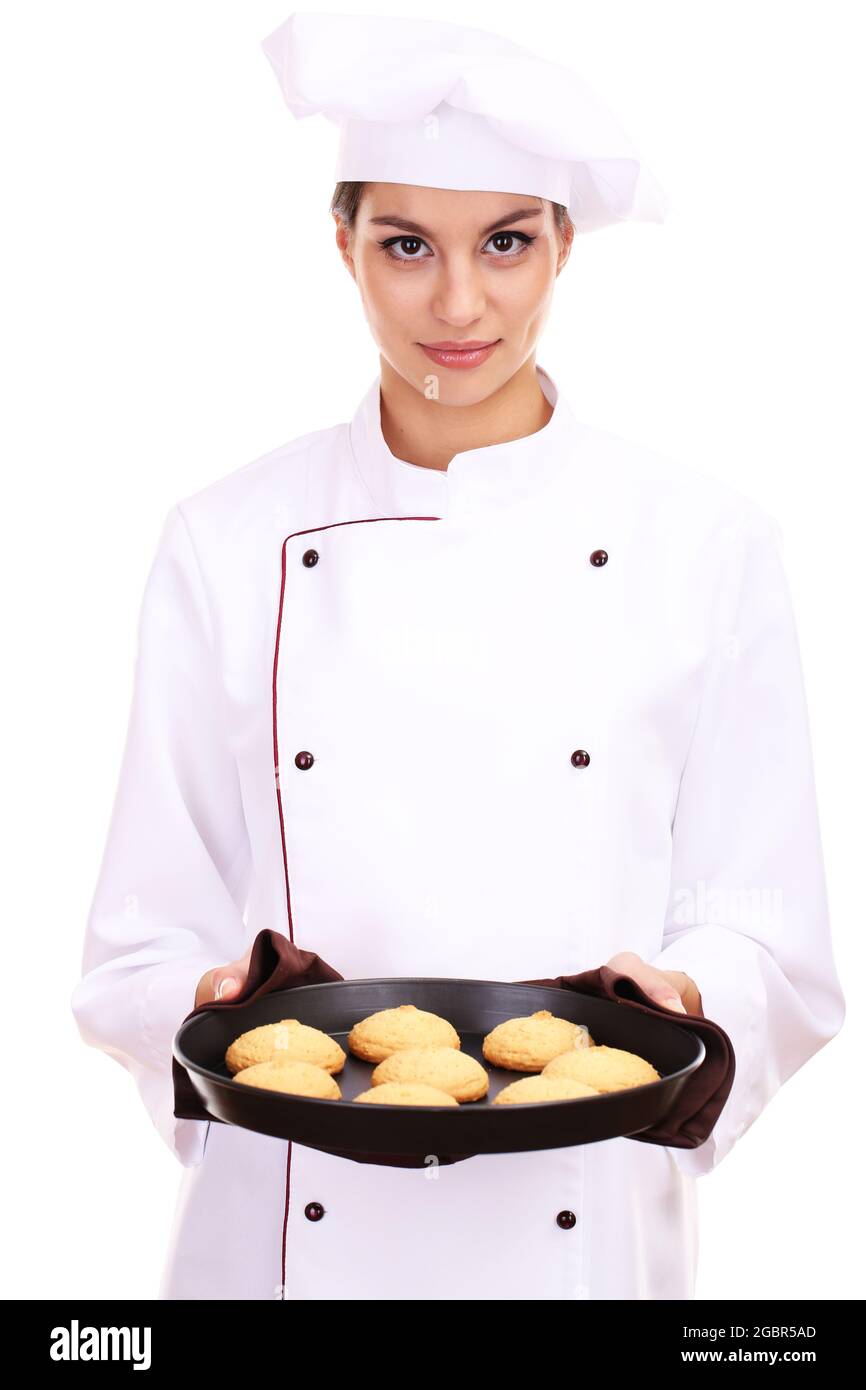 Portrait of young woman chef with cakes on dripping pan isolated on ...