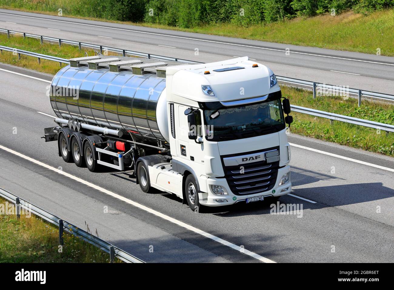 White DAF XF semi tanker truck hauls goods along motorway, elevated ...