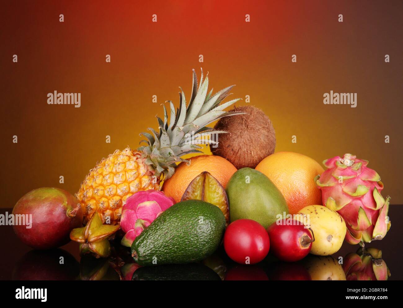 Composition of exotic fruits on colorful background Stock Photo - Alamy
