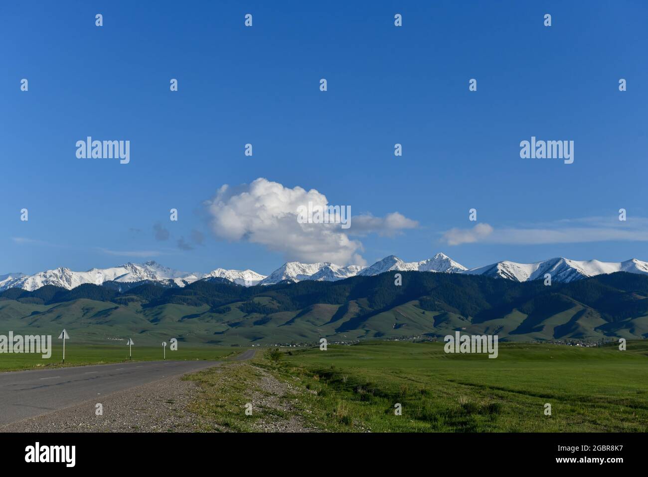 Mountain landscape with clouds and road, Kazakhstan, Almaty region ...
