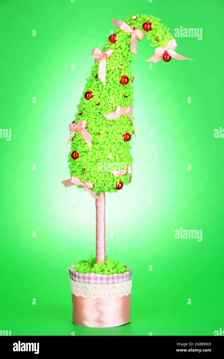 Christmas tree with curved tip on green background Stock Photo - Alamy