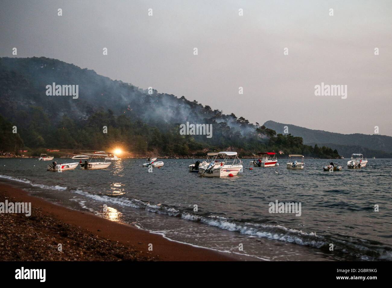 Fire fighters work to stop forest fires near villages at Marmaris ...