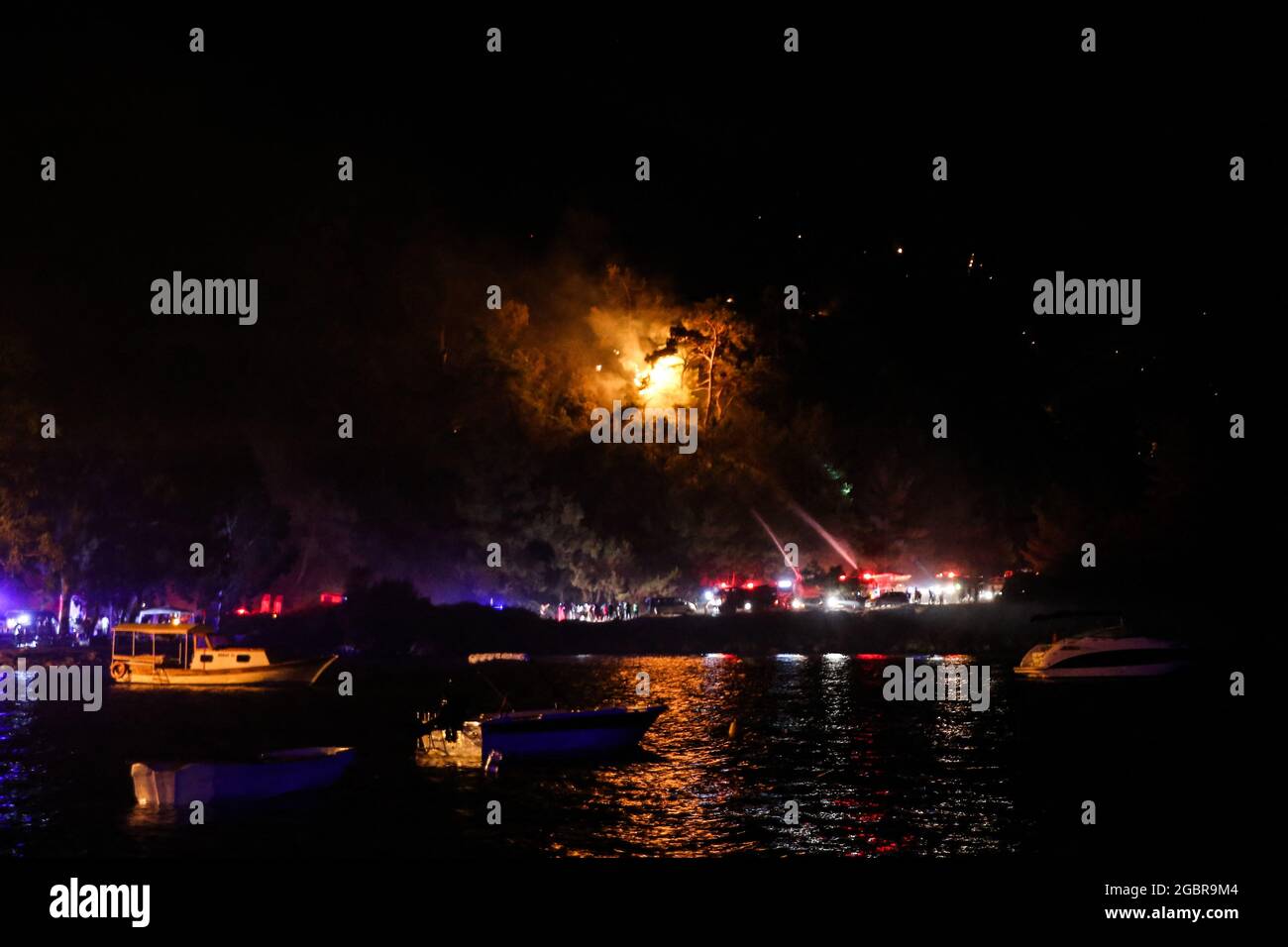 Fire fighters work to stop forest fires near villages at Marmaris ...