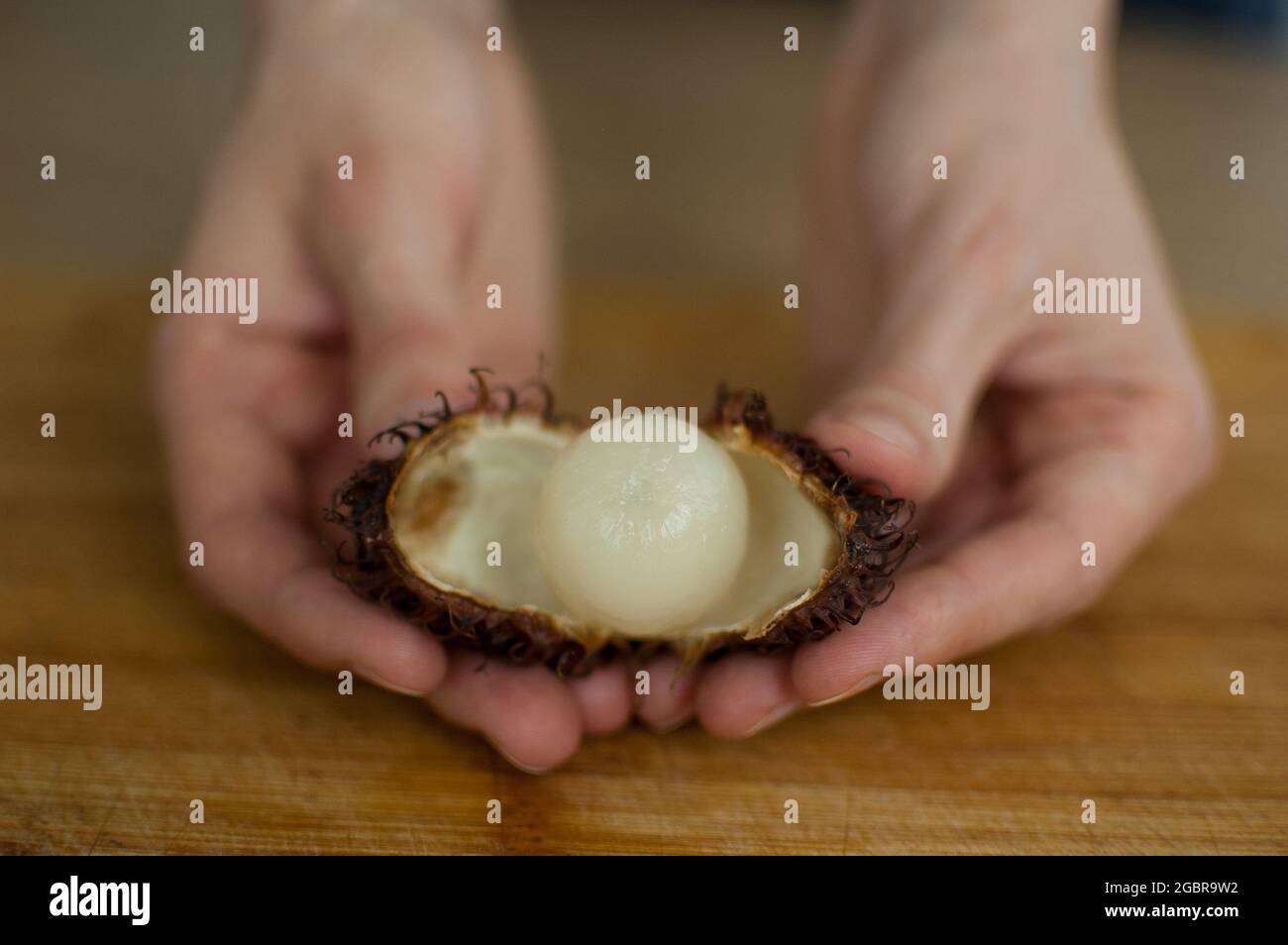 Ripe rambutan and leechy or lychee fruits on wooden table. Healthy food ...