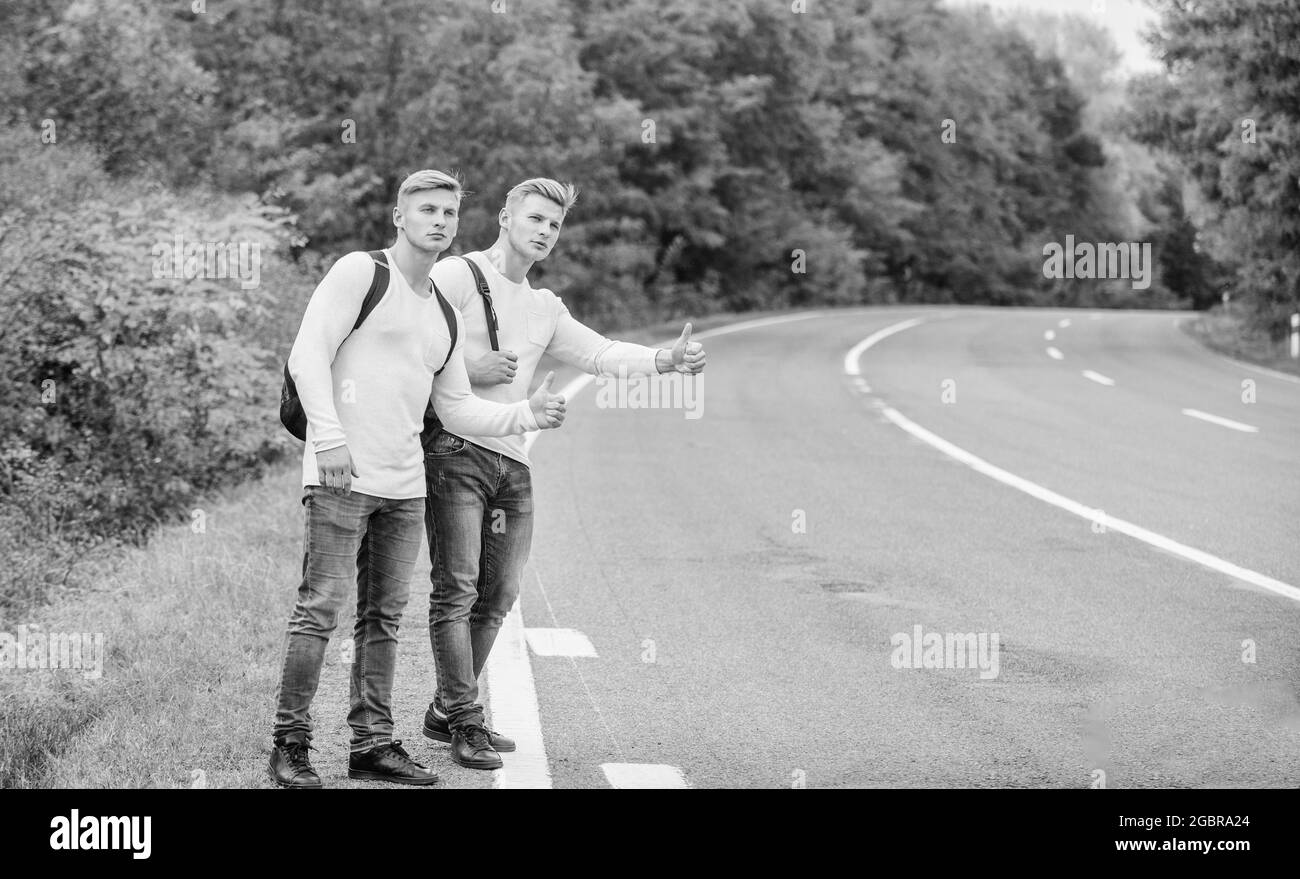 catching rides. stop car with thumb up gesture. hitchhiking and ...