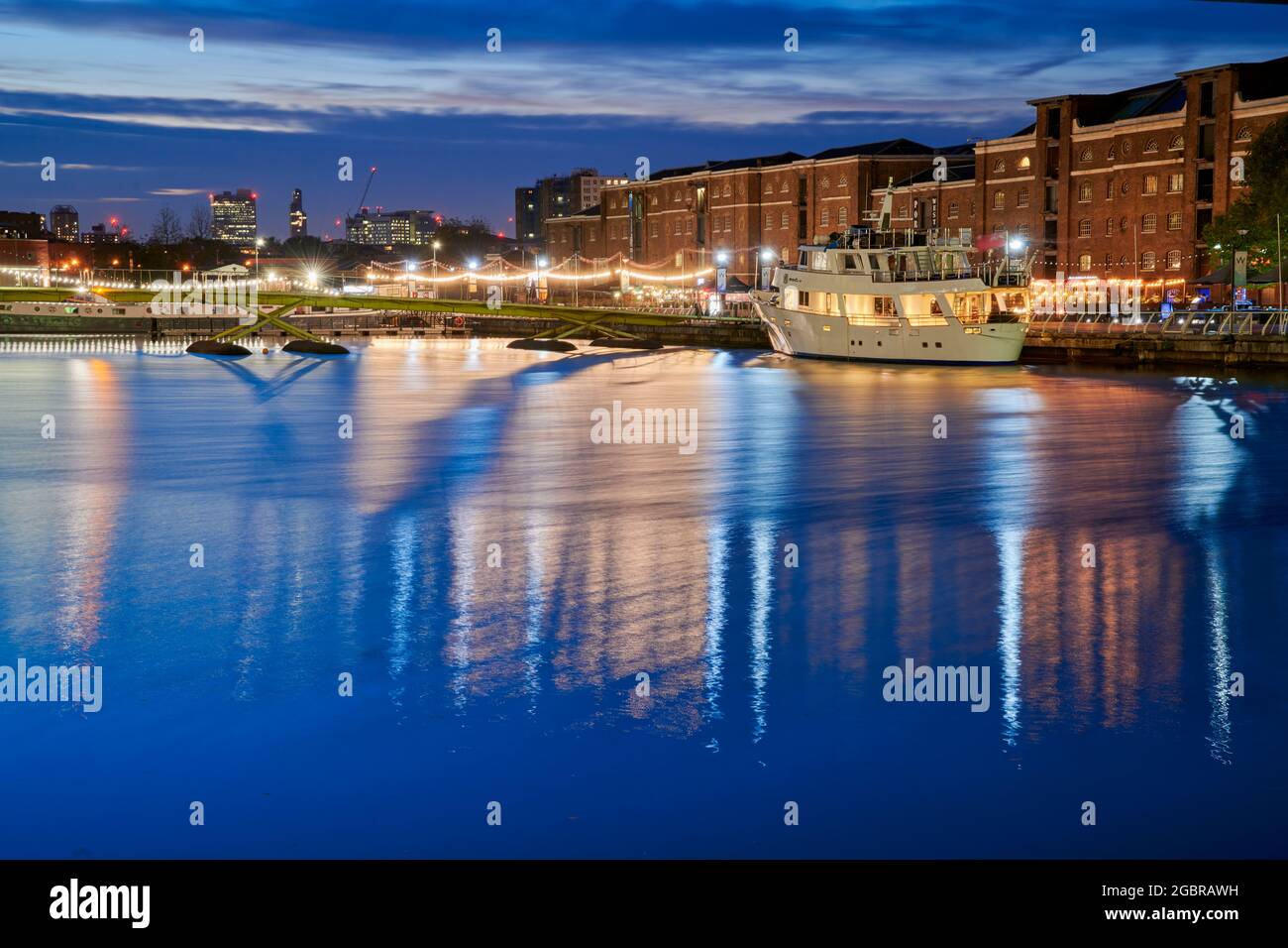 Night view depicting a boat on the River Thames, Canary Wharf, London ...