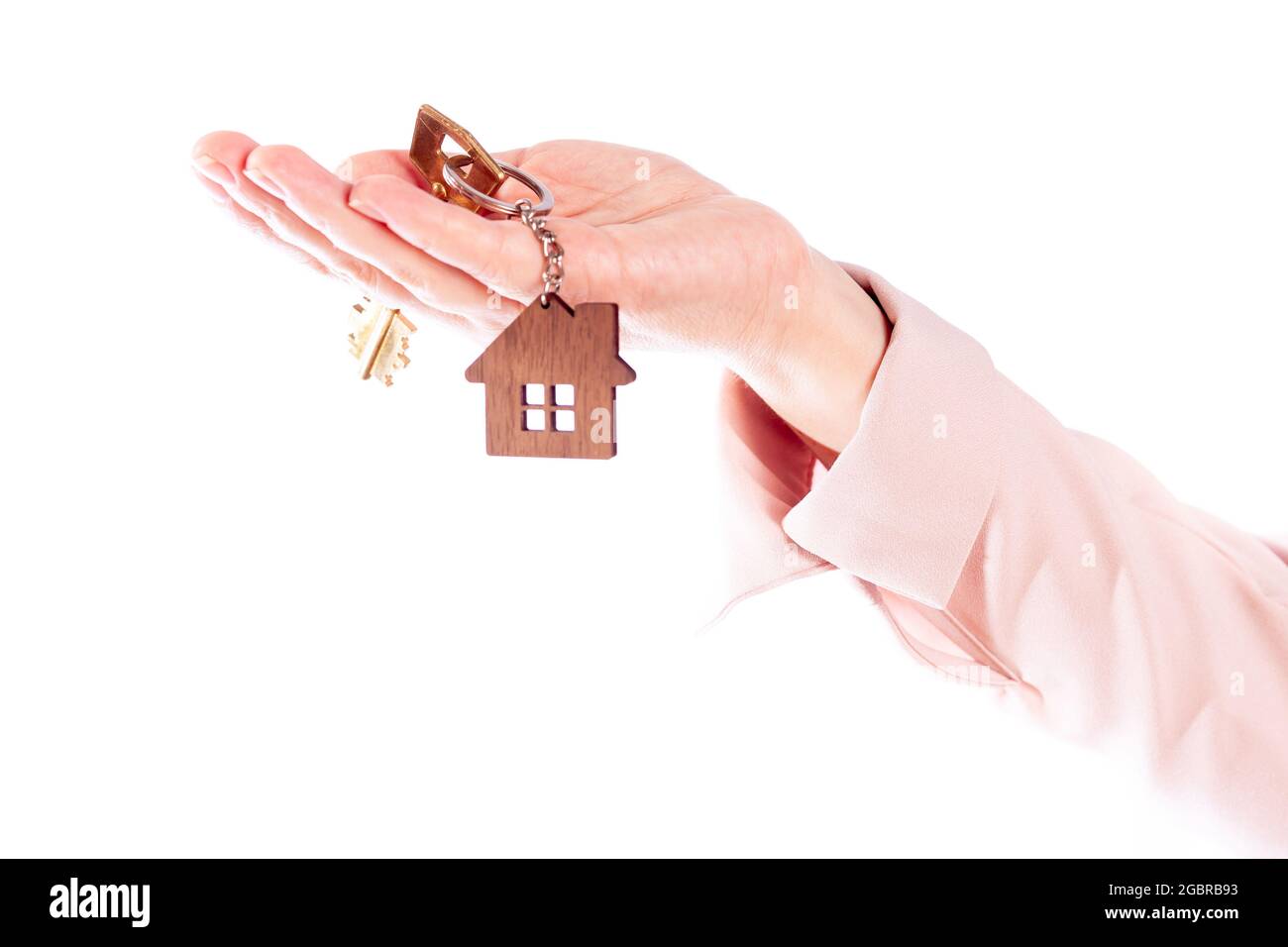 buying a house, hand with keys to the house, isolate on a white ...