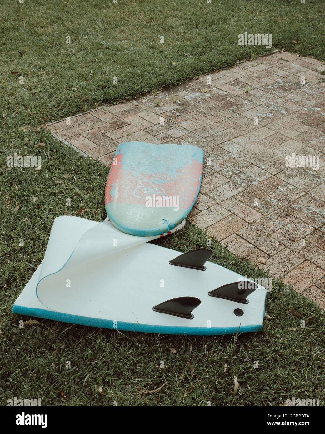 Vertical shot of a broken surfboard Stock Photo - Alamy