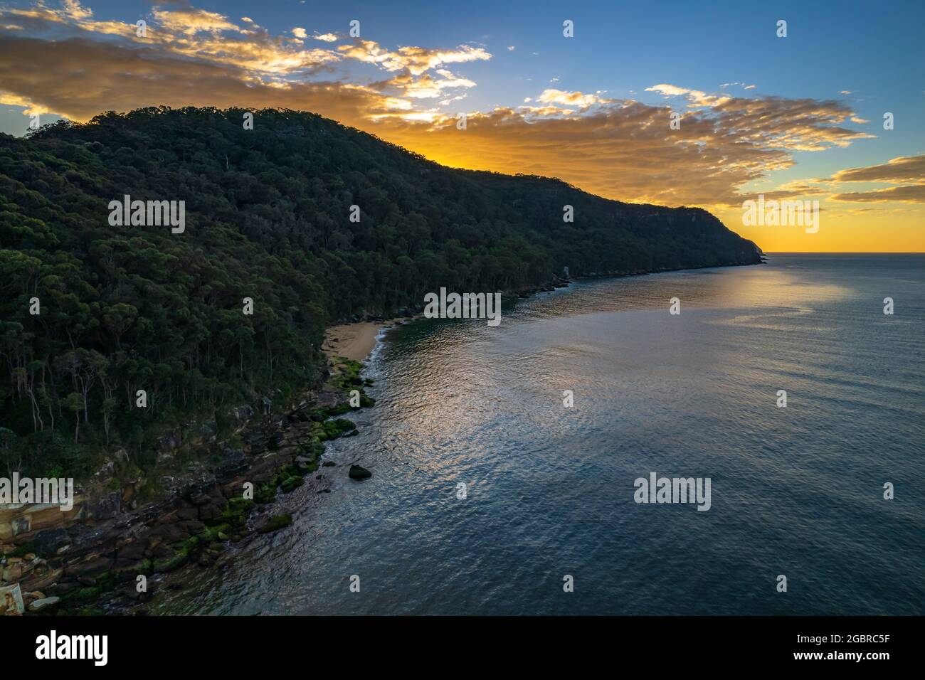 Mountain and sea sunrise in Brisk Bay from Patonga Beach on the Central ...