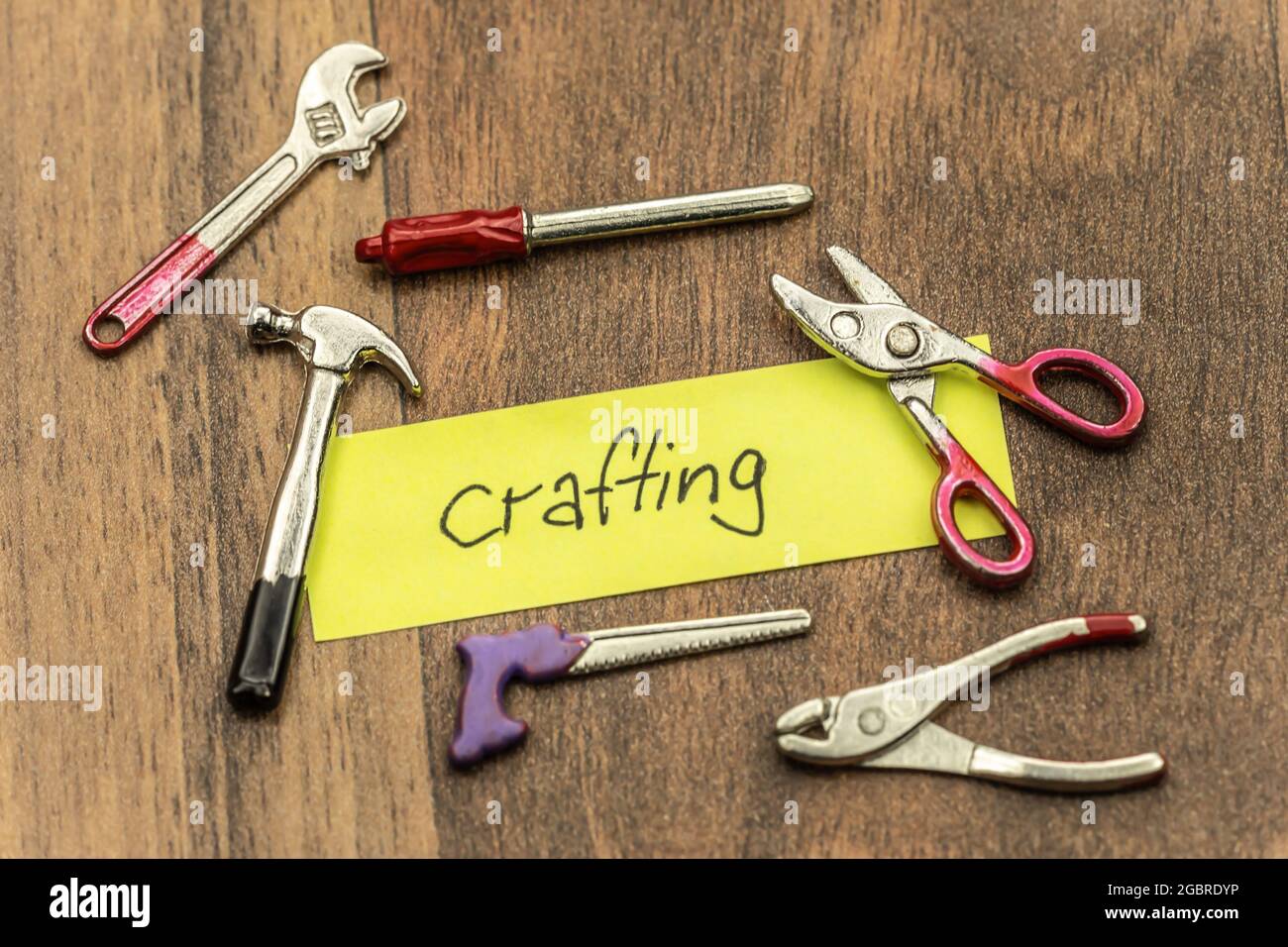 Crafting concept: Handwritten lettering "crafting" on a sticky note ...