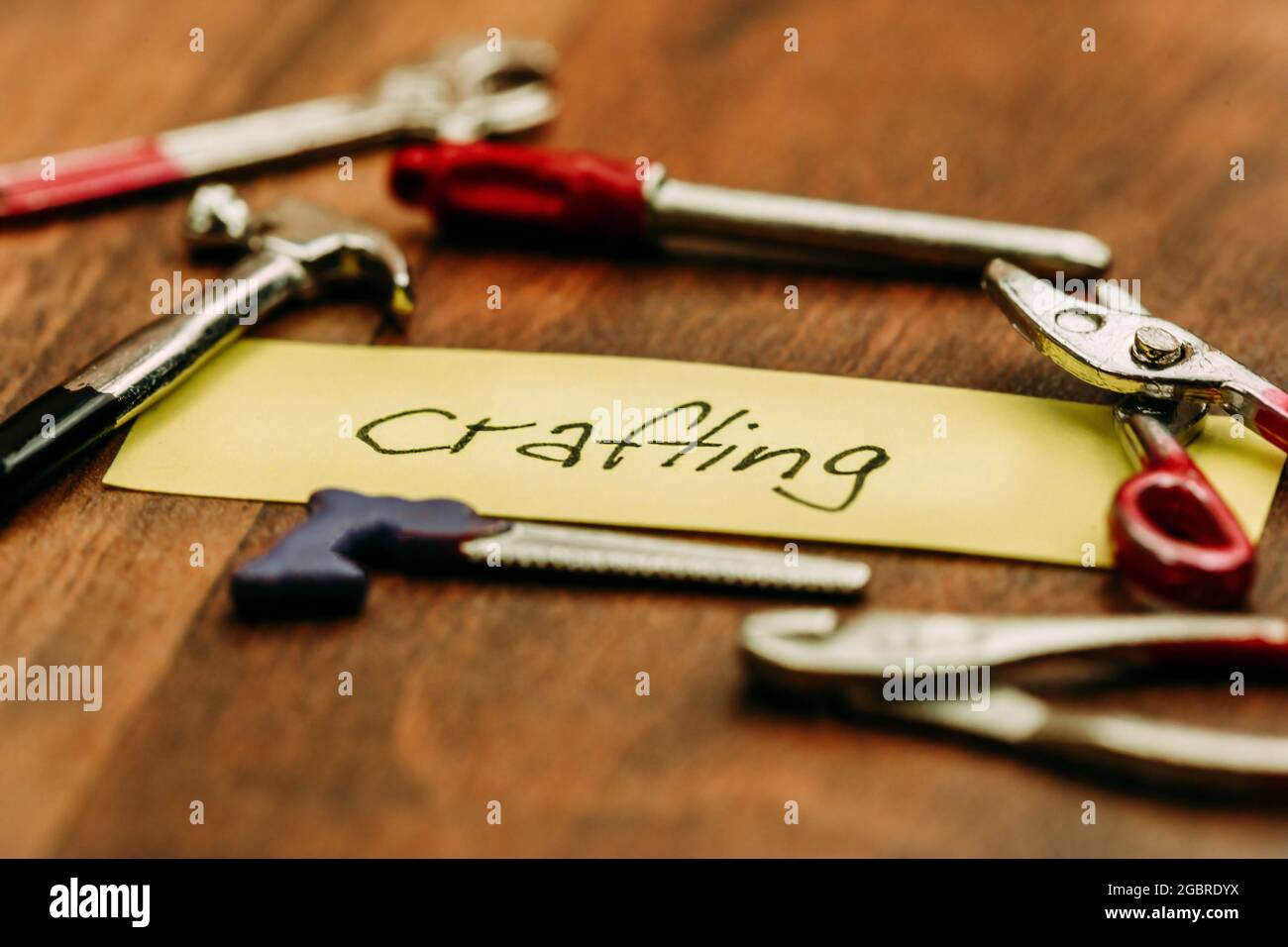 Crafting concept: Handwritten lettering "crafting" on a sticky note ...