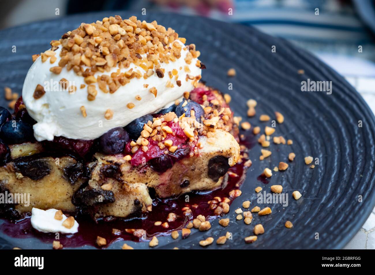 High angle shot of a plate with delicious berry pie, vanilla ice cream ...