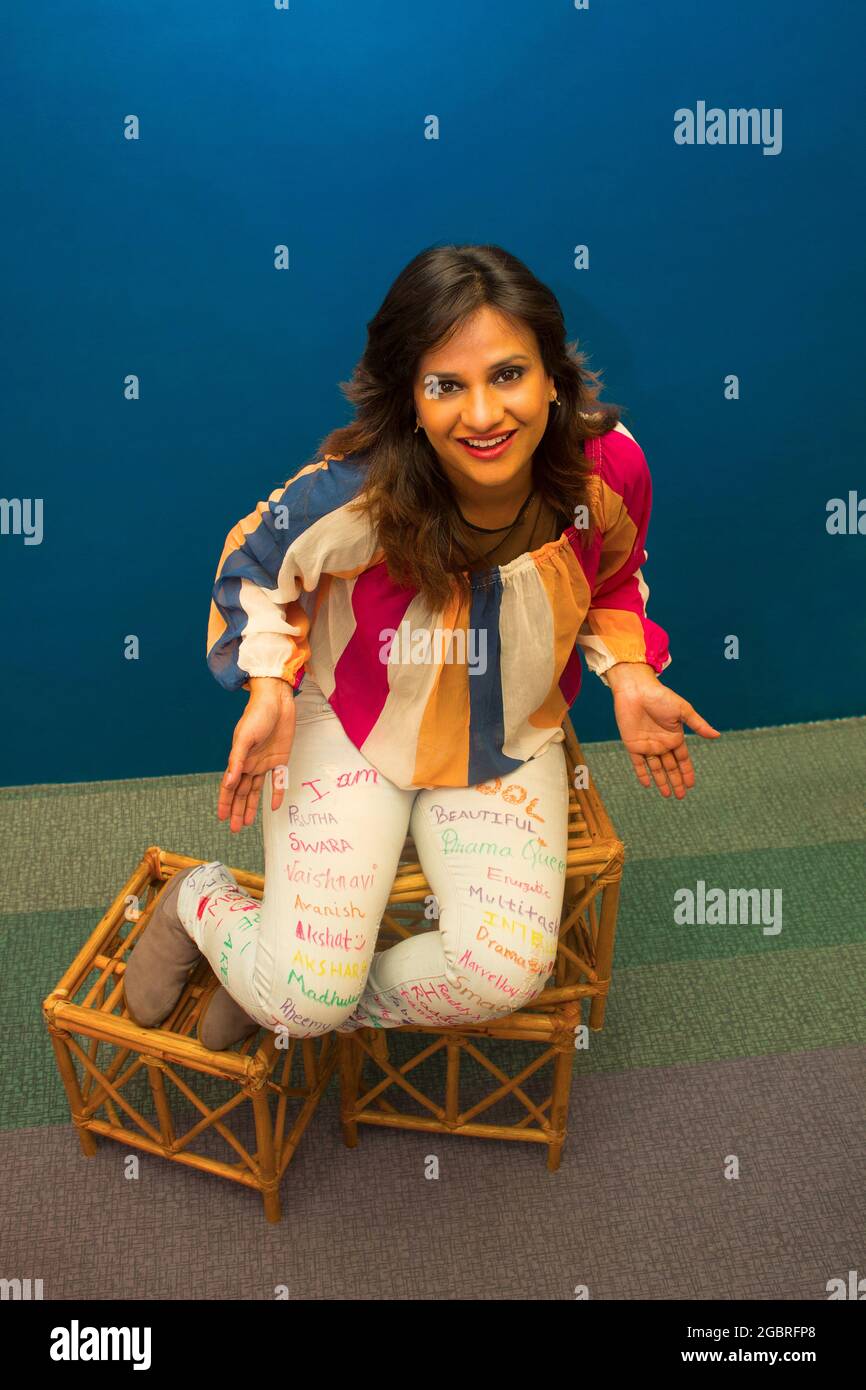 Indian young girl in white dress sitting on wooden cubes Stock Photo ...