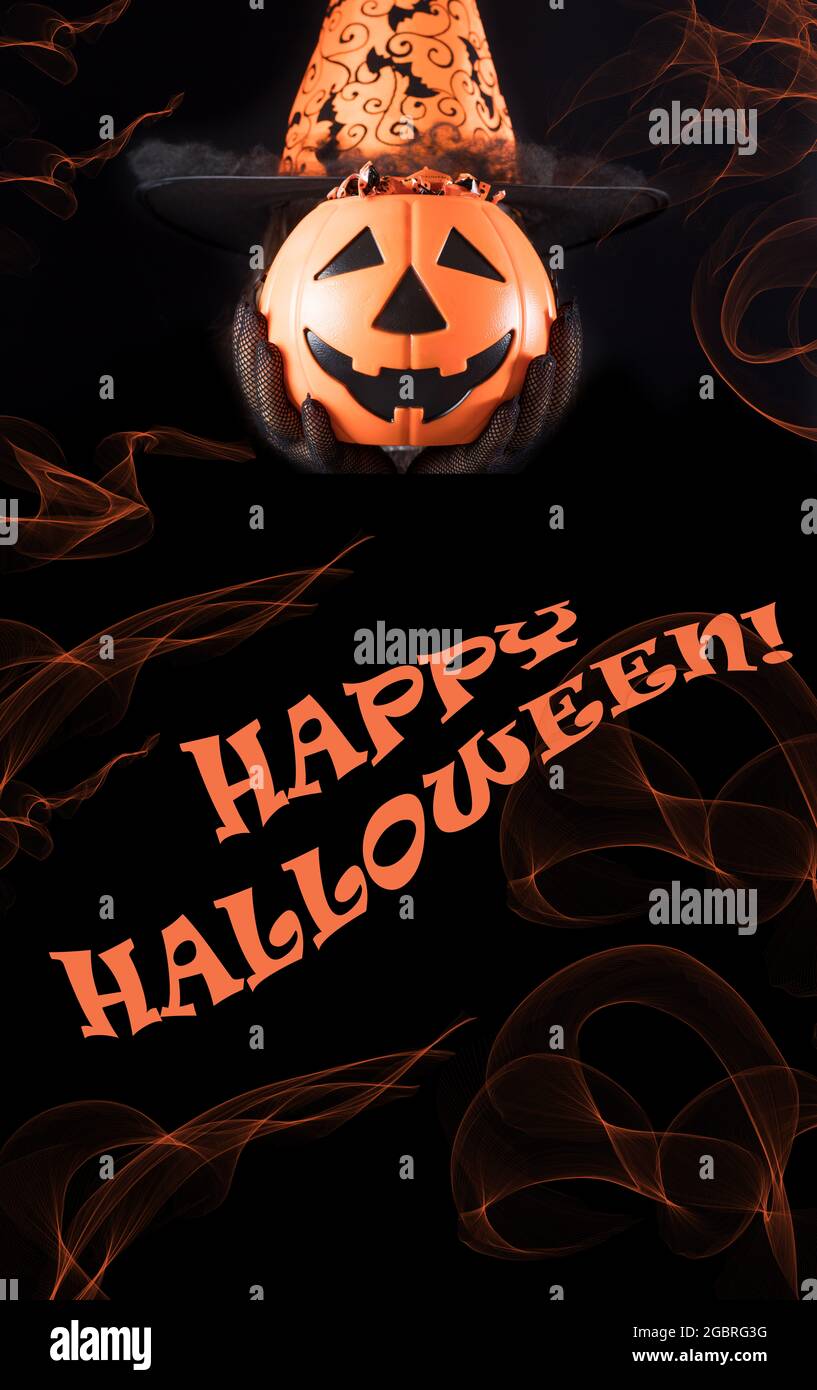 Vertical Happy Halloween black card. A woman in a hat holds a bucket of ...