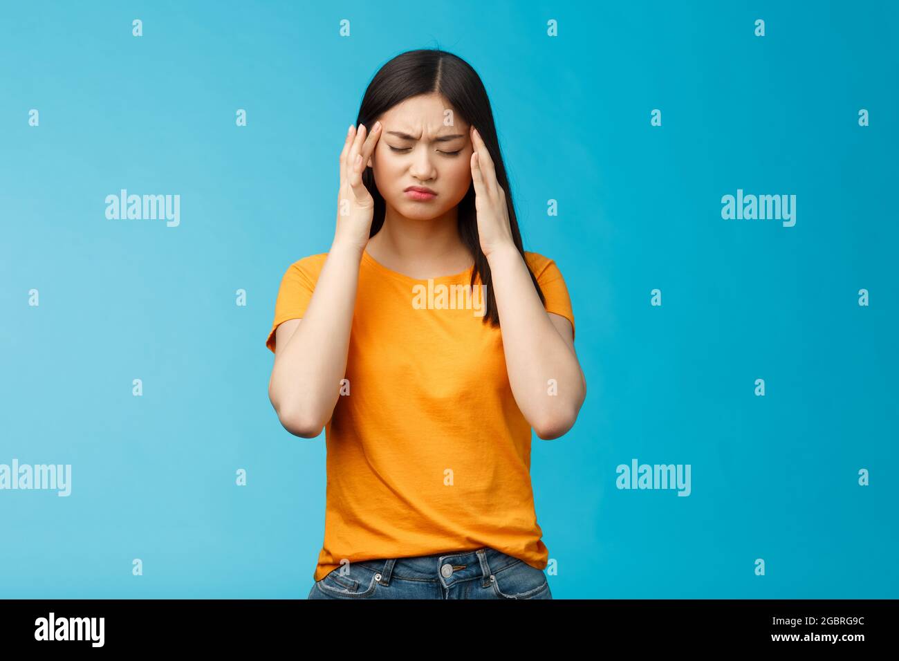 Distressed tired asian woman dark haircut cringe touch temples, suffer ...