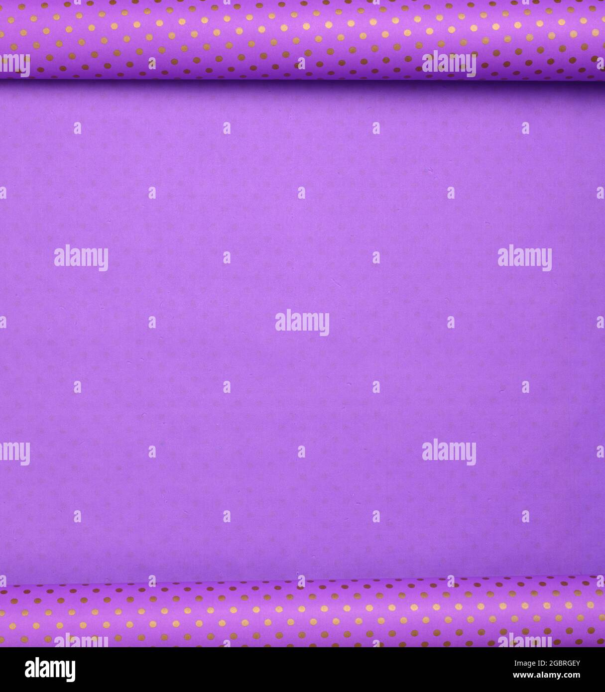 Purple paper bundle in a golden dot deployed, wrapping paper, copy ...