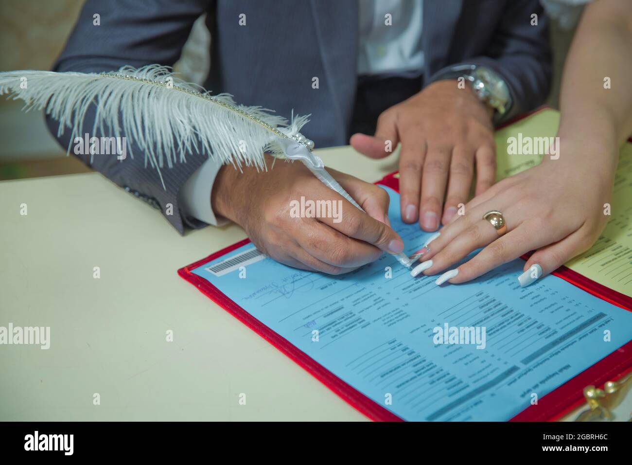 The newlyweds put their signature on the marriage . the bride in a ...