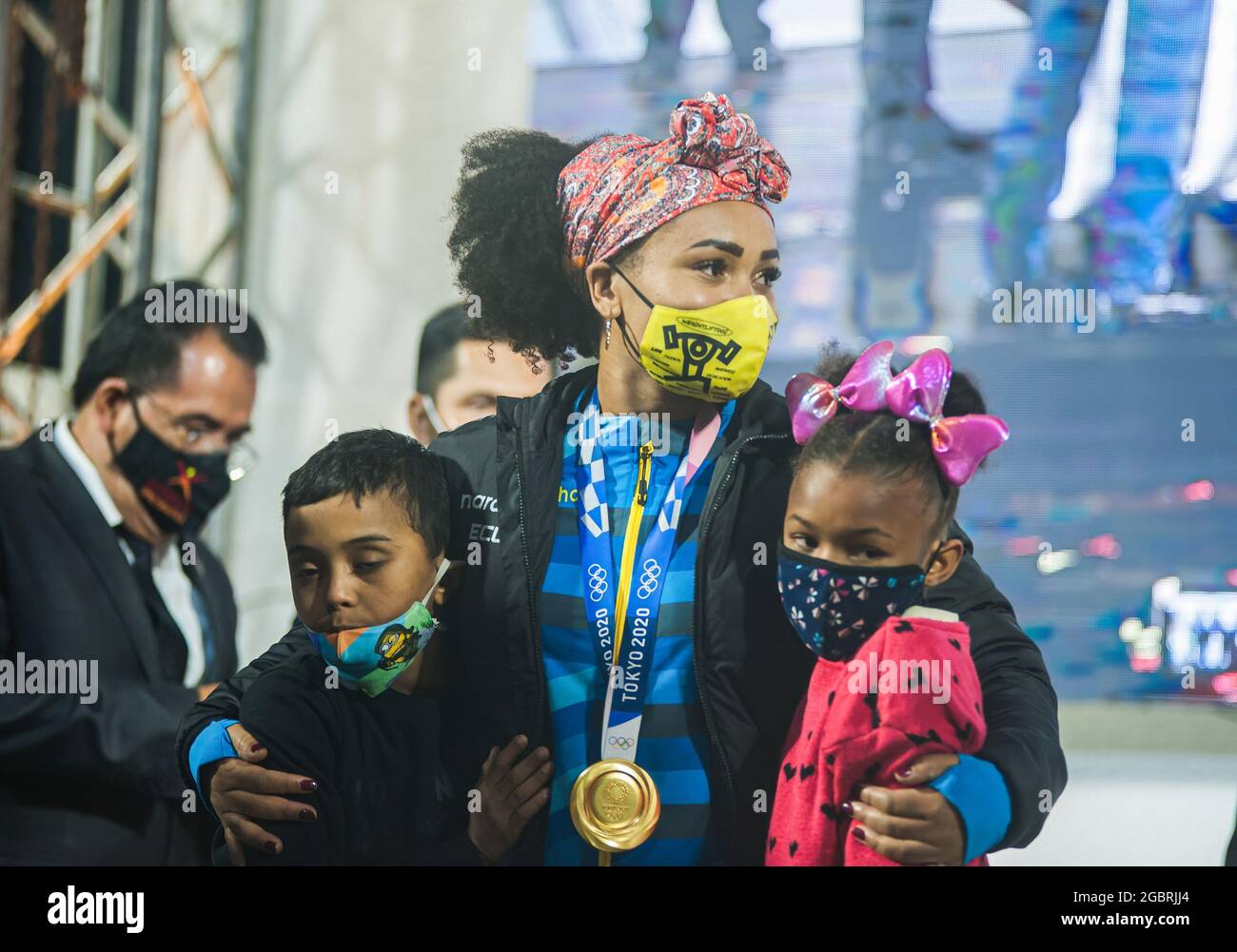 The gold medalist, Neisi Dajomes hugs her niece and nephew on her ...