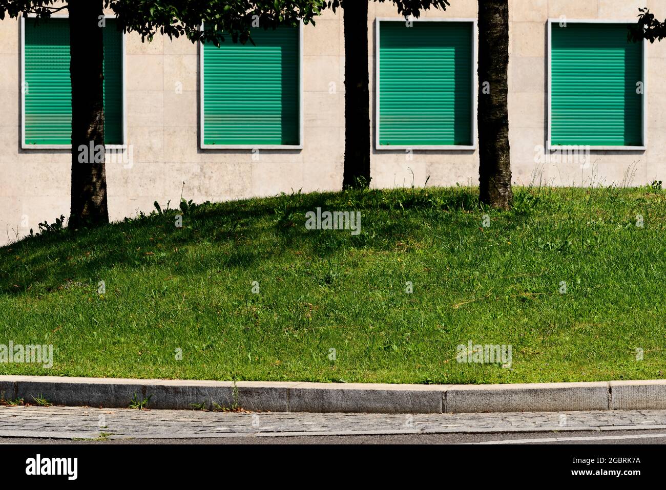 Green windows overlook green lawn Stock Photo - Alamy