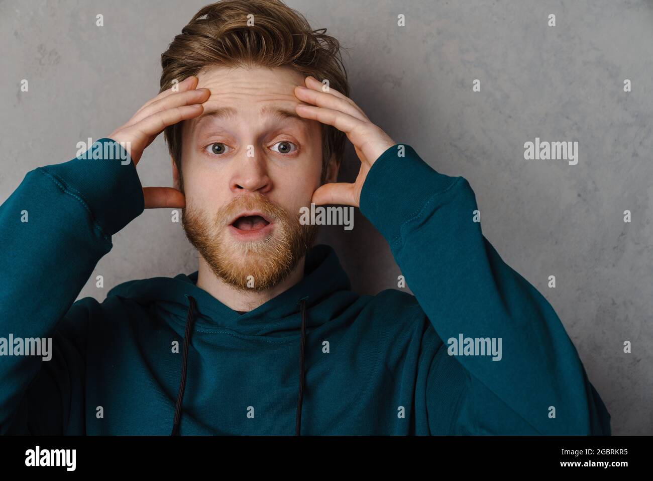 White Ginger Man With Beard Expressing Surprise At Camera Isolated Over