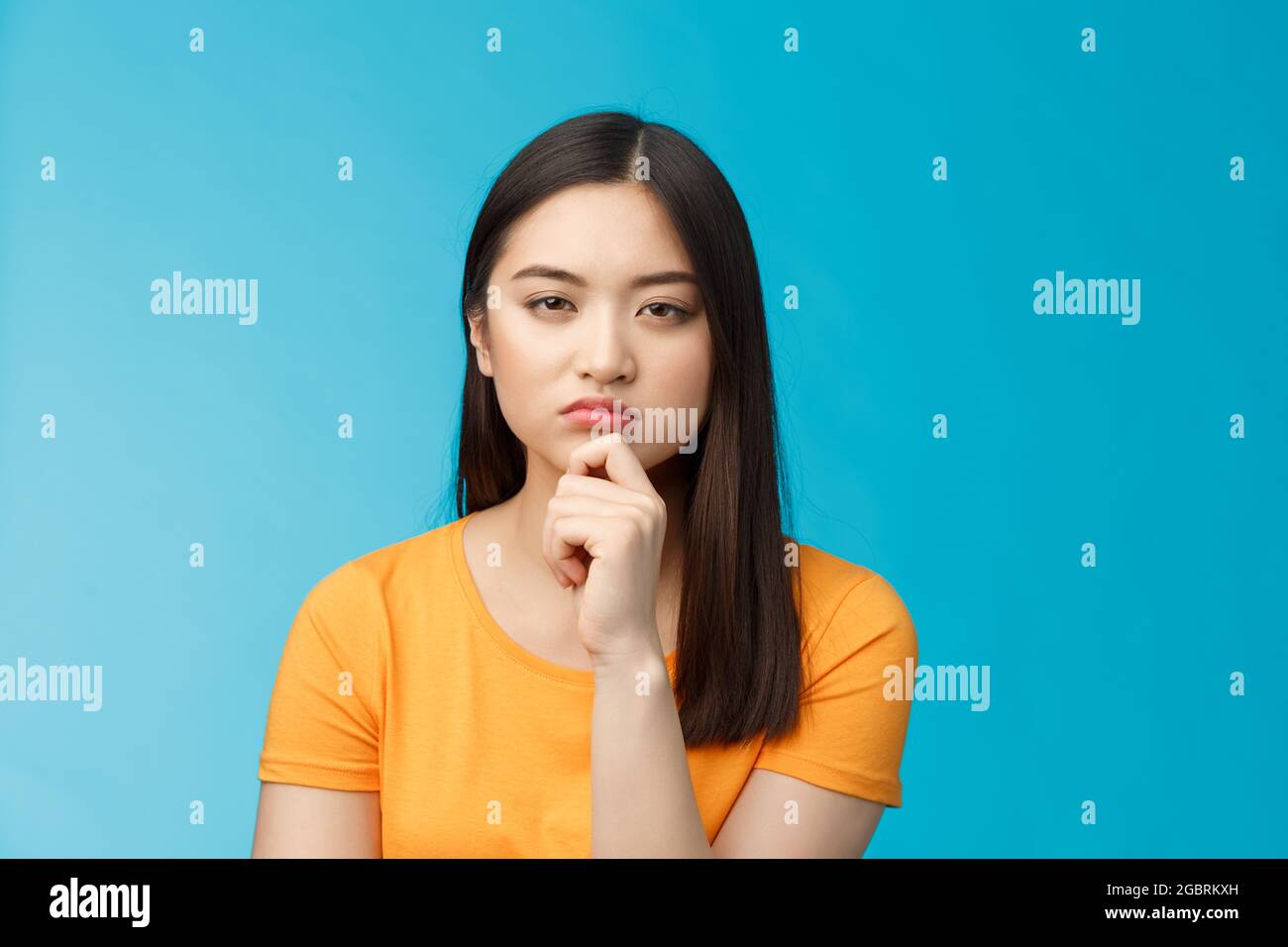 Close-up serious-looking suspicious female asian look disbelief ...