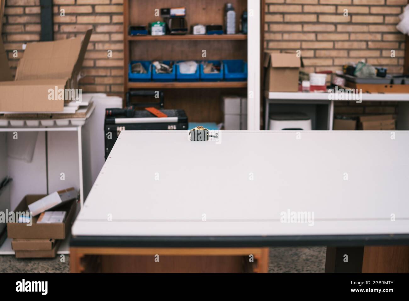 Table with a tape measure on it in a workshop Stock Photo - Alamy