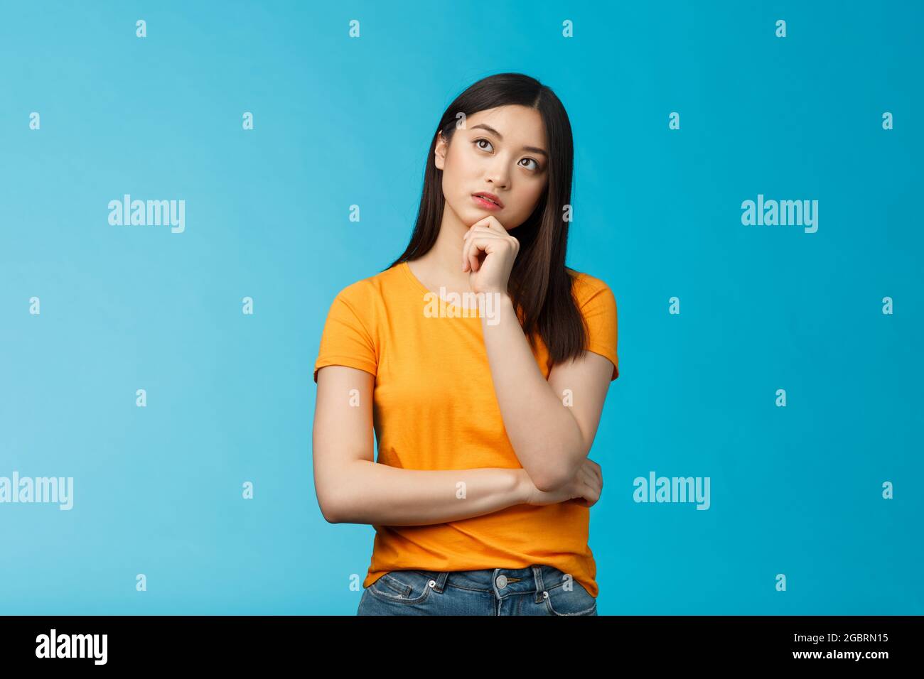 Thoughtful dreamy smart asian girl thinking, making plan inside head ...