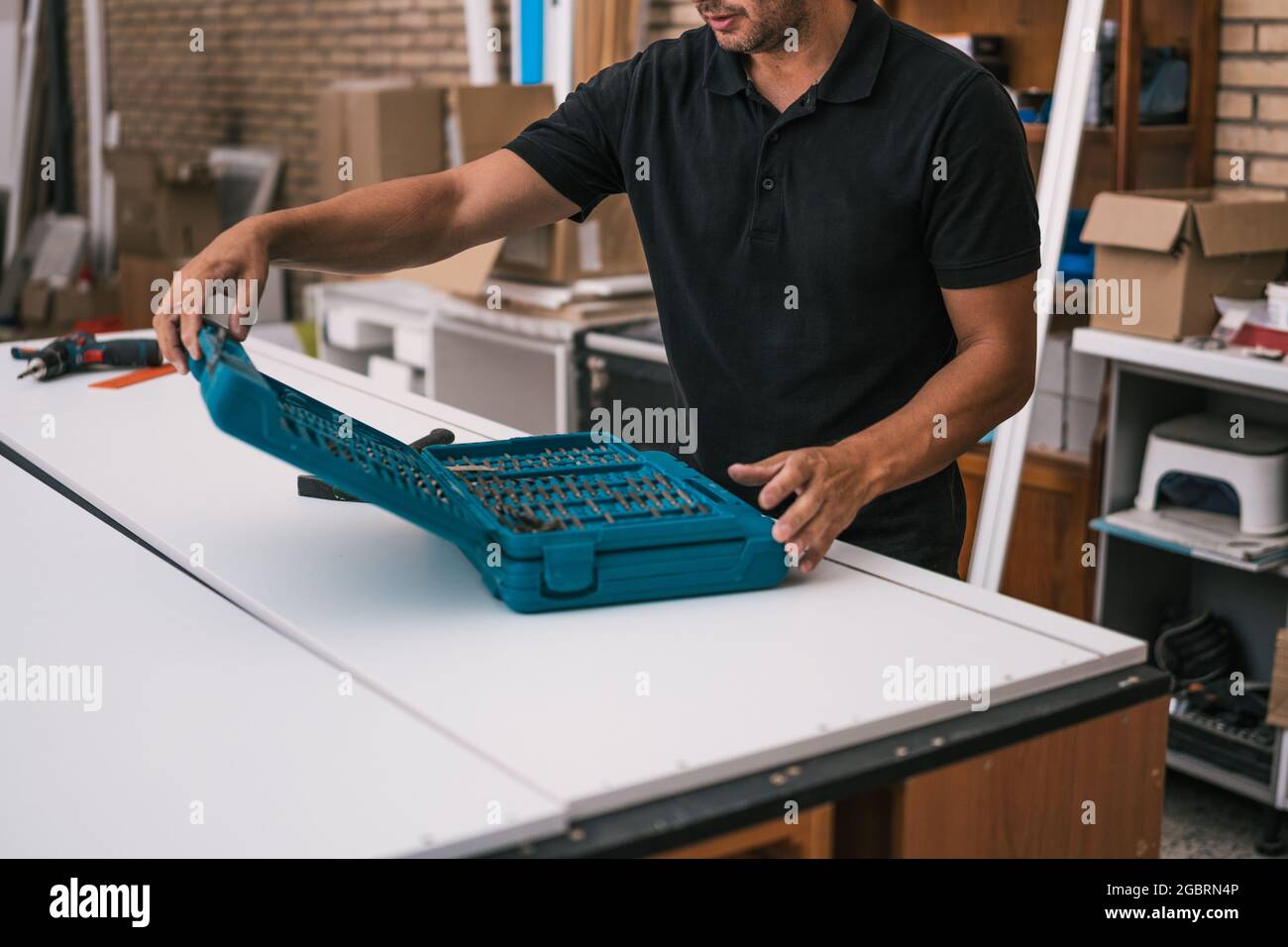 Man opening a toolbox in a furniture construction workshop Stock Photo ...