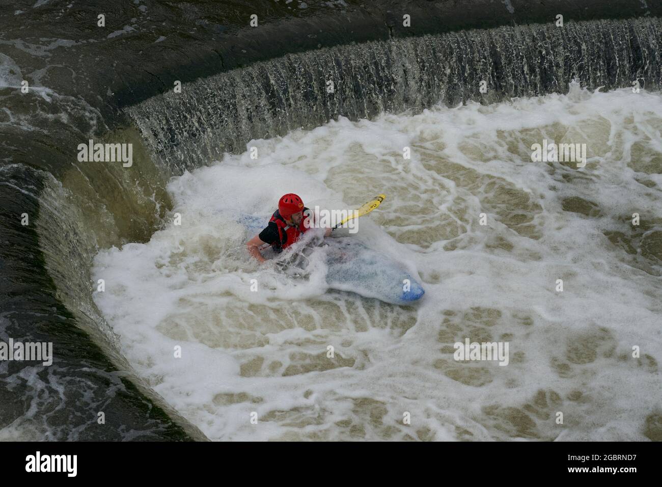 Kayaking over Pulteney Weir on the River Avon in the historic city of ...