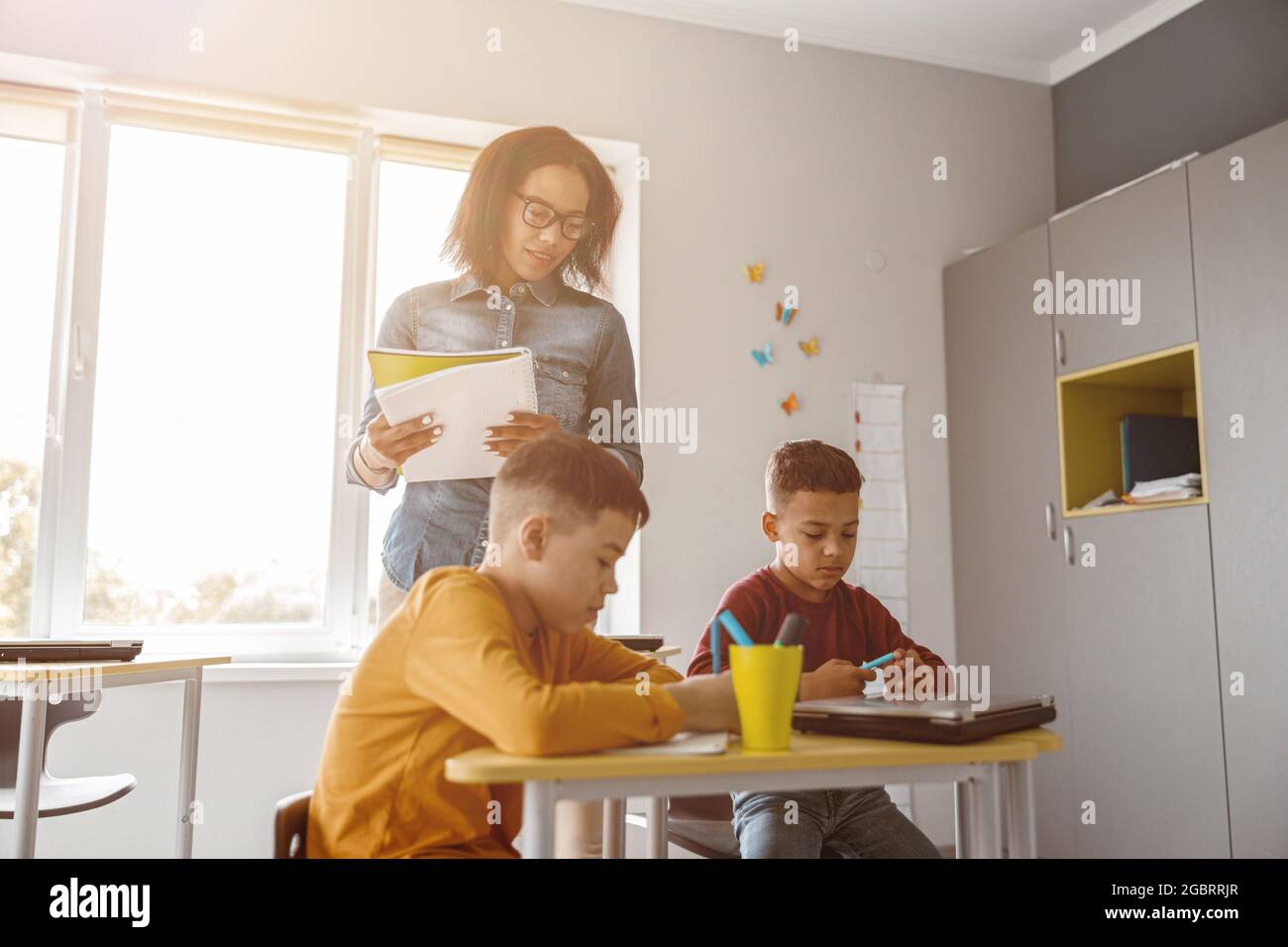 Two boys writing during a lesson and a test at school Stock Photo - Alamy