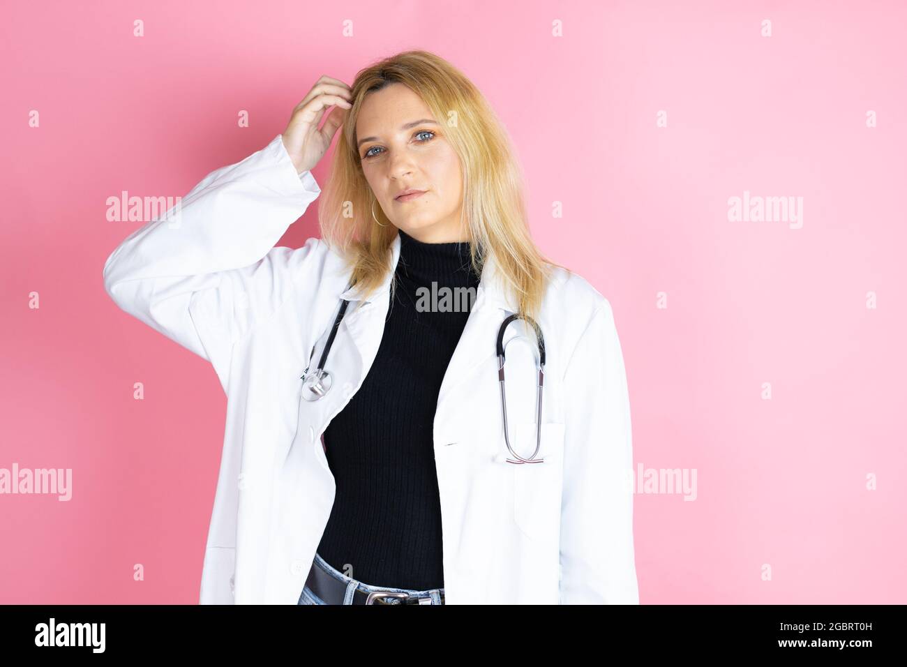 Young blonde doctor woman wearing stethoscope standing over isolated ...