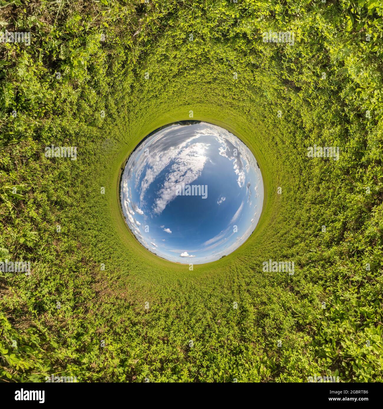 blue sky ball in middle of swirling asphalt road or field. Inversion of ...