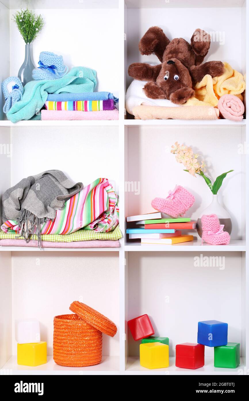 Beautiful white shelves with different baby related objects Stock Photo ...