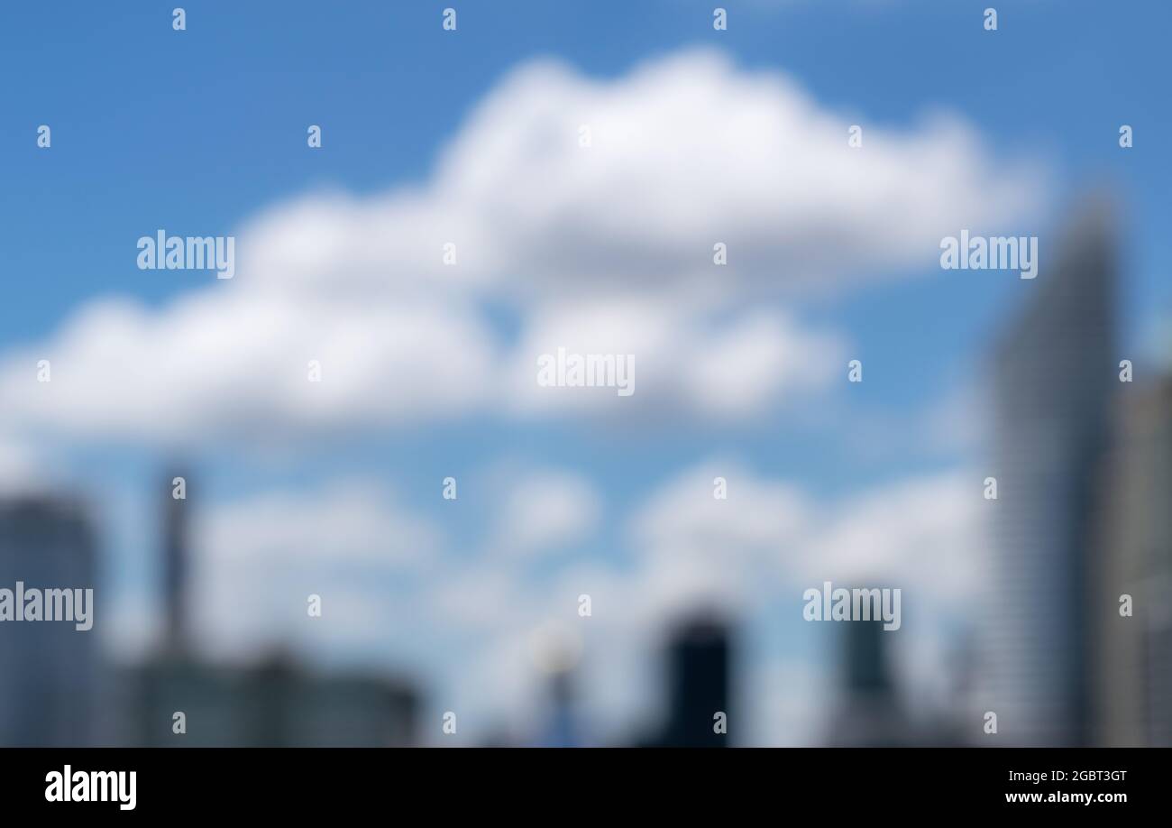 Abstract blurred blue sky and clouds background in city. Defocused tall ...