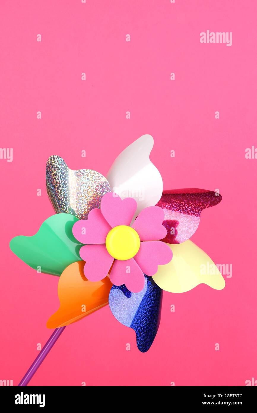 Colored pinwheel on pink background Stock Photo - Alamy