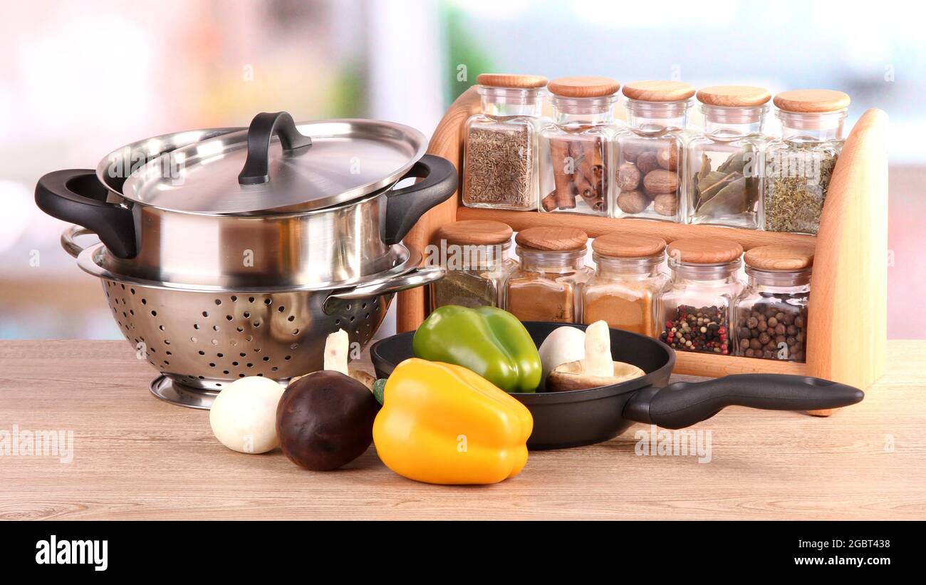 composition of kitchen tools,spices and vegetables on table in kitchen ...