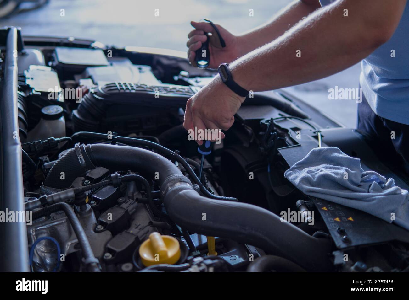 Auto mechanic working and repairing a car engine in a garage wit Stock ...