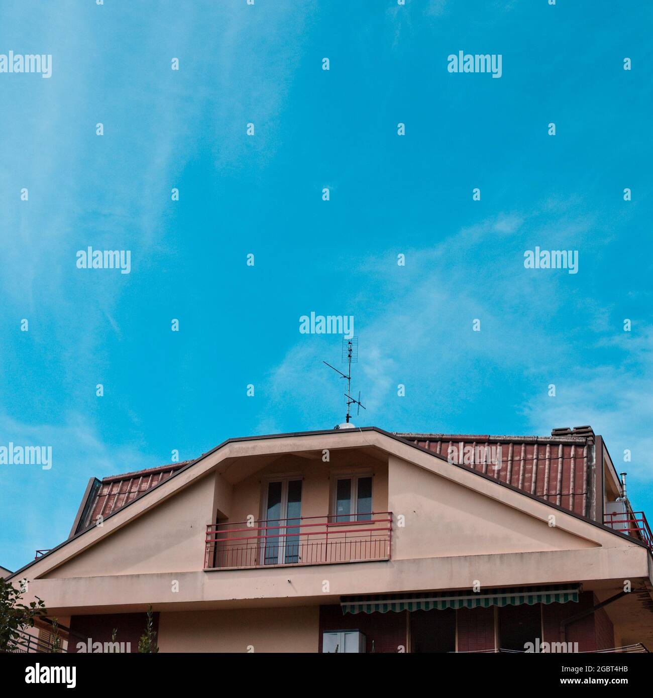 Italian residential building with prismatic roof finished with tiles ...