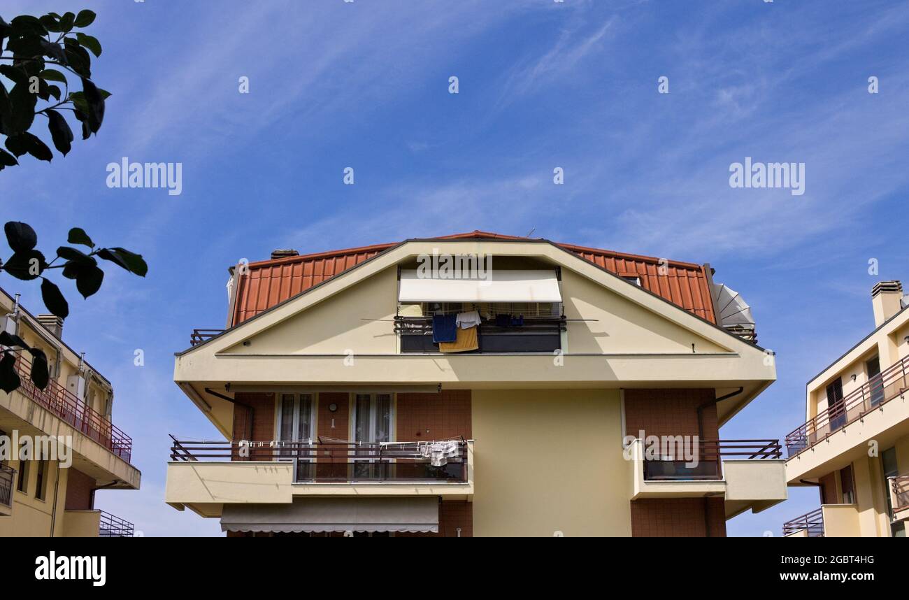 Italian residential building with prismatic roof finished with tiles ...