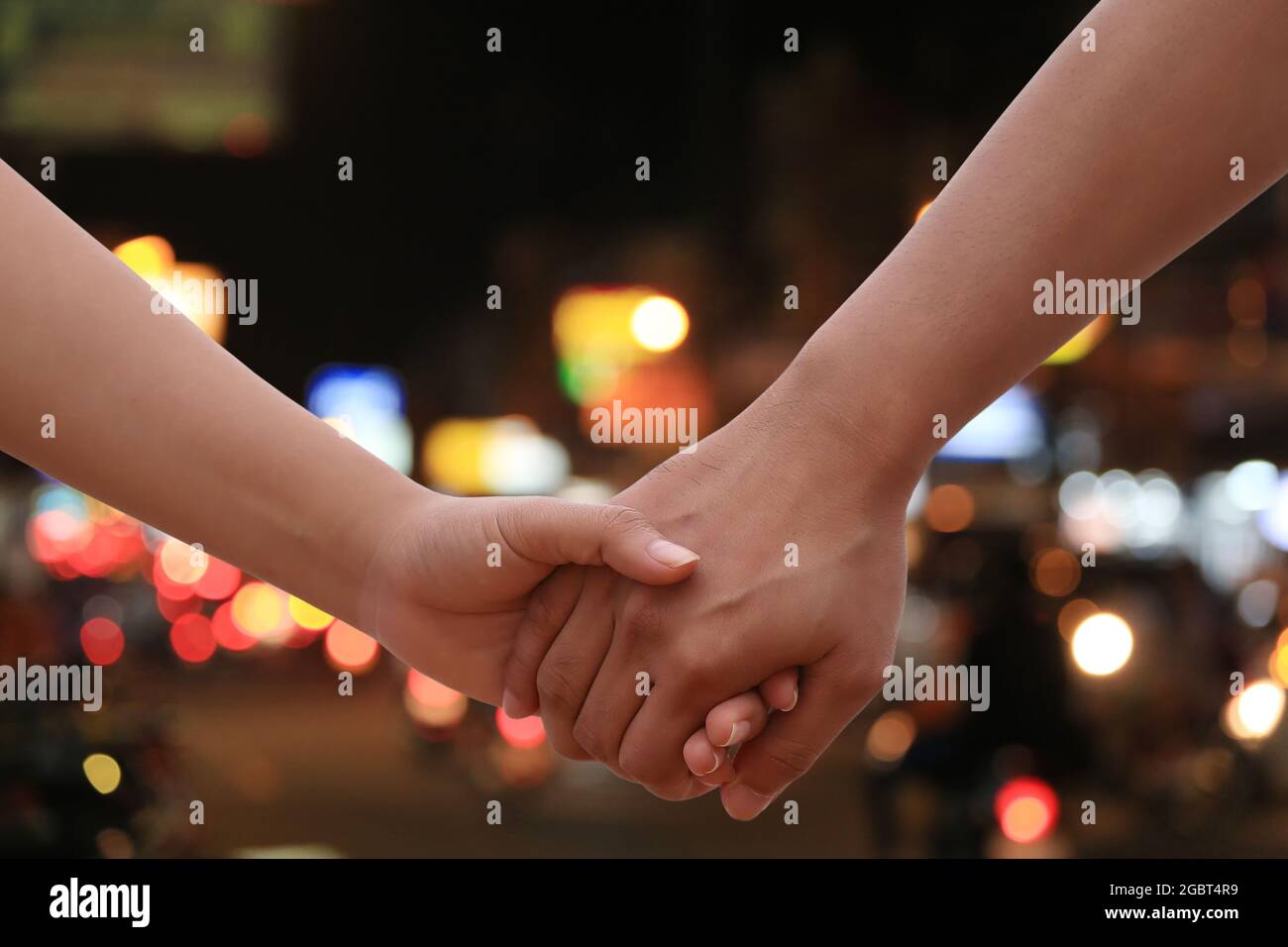 Lovers hand in hand, Couples holding hands on night lights in the city ...