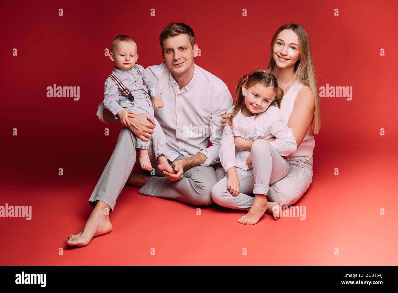happy family of four rejoice together in the studio Stock Photo - Alamy