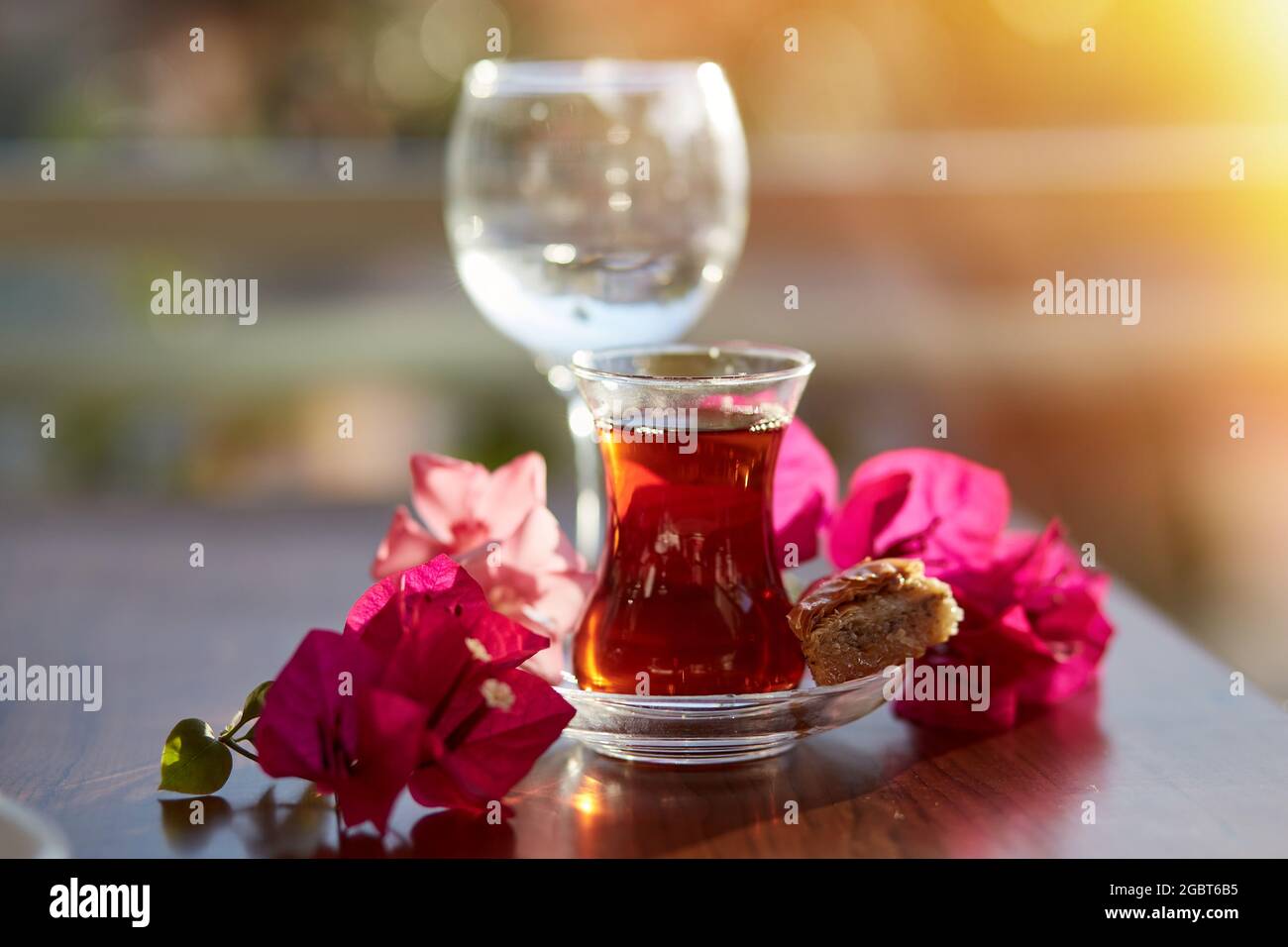 Turkish delight and traditional glass of turkish tea with bougainvillea ...
