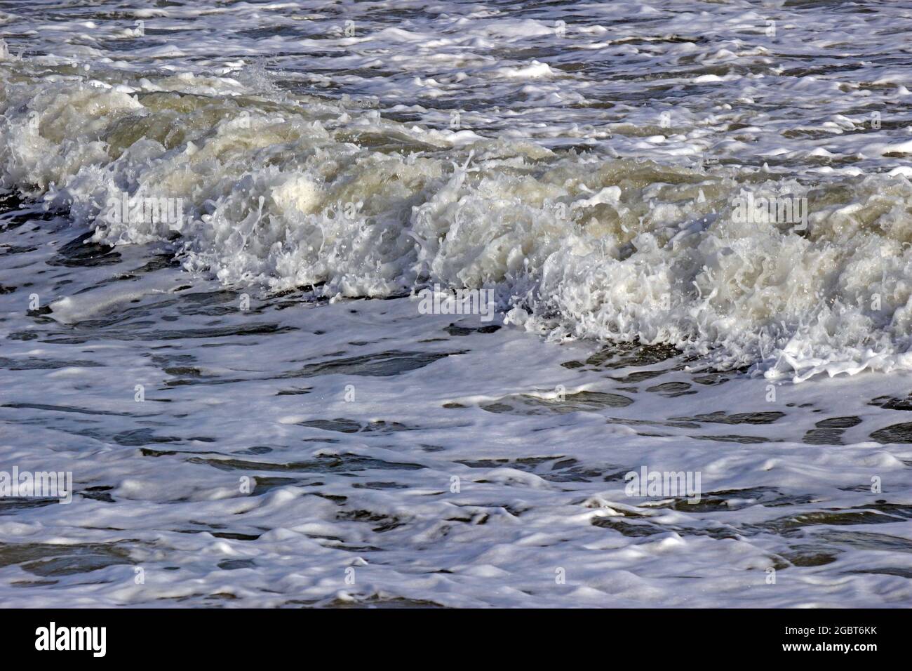 Close-up of a small frothy wave Stock Photo - Alamy
