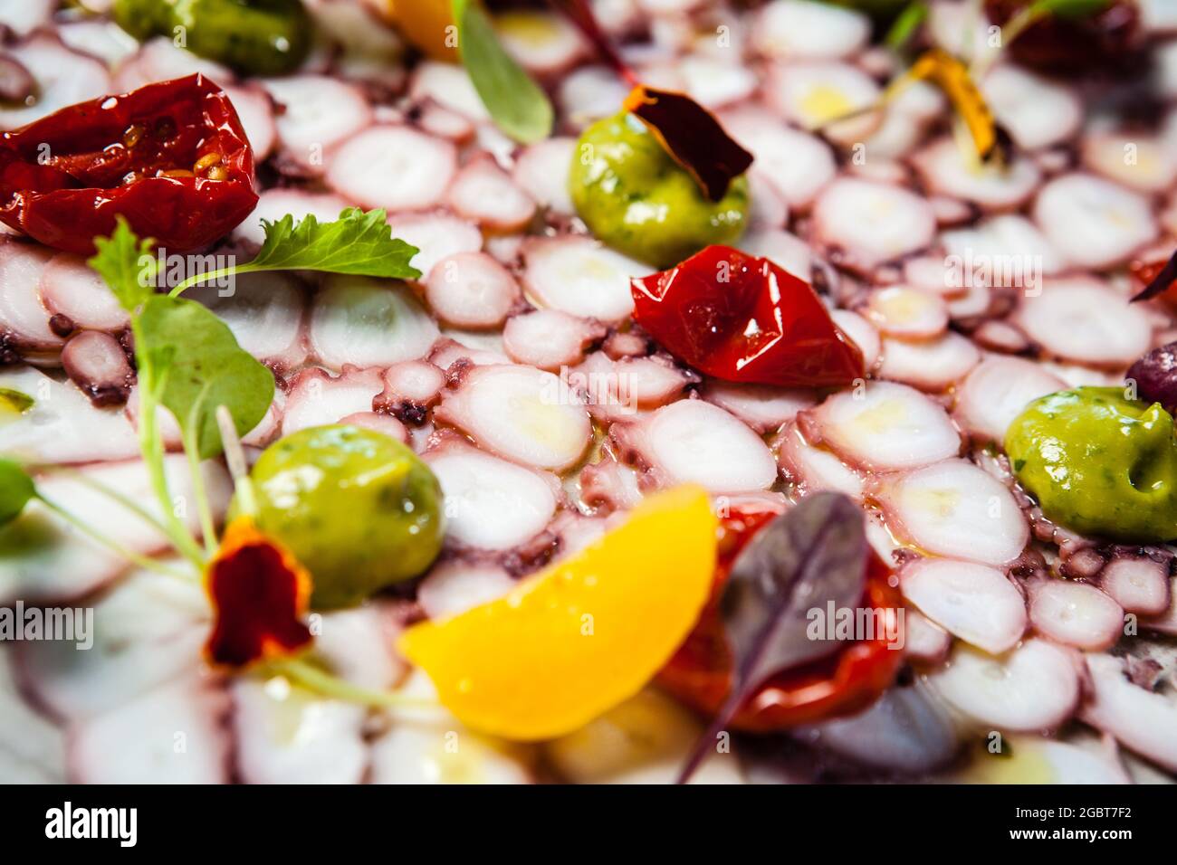 Octopus carpaccio. Spinach cream, cherry tomatoes. Delicious healthy ...