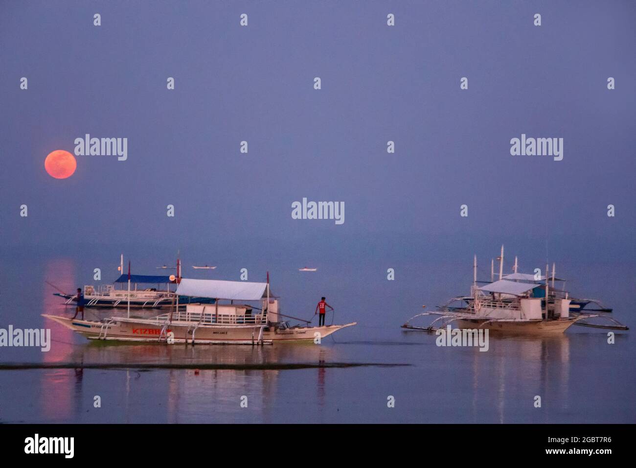 boats in the water beneath moon Stock Photo - Alamy