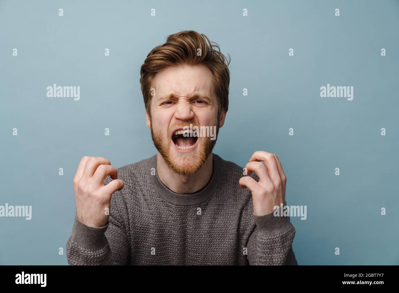 White ginger man with beard screaming and gesturing at camera isolated ...